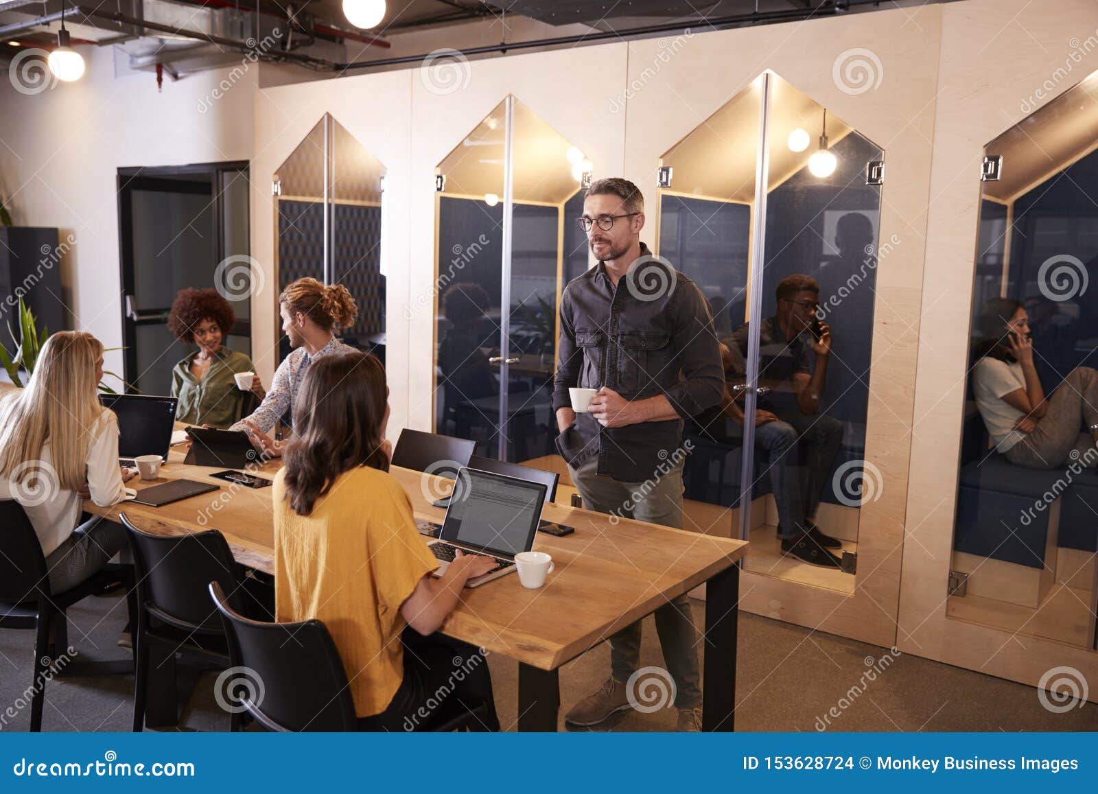 Creative Business Colleagues Drinking Coffee and Talking in Their ...