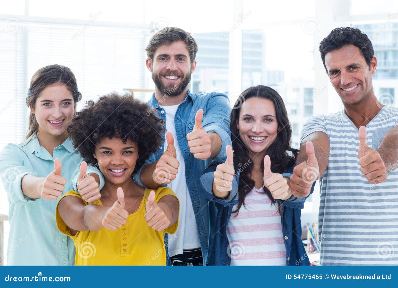 Creative Business People Gesturing Thumbs Up by Blackboard Stock Image ...