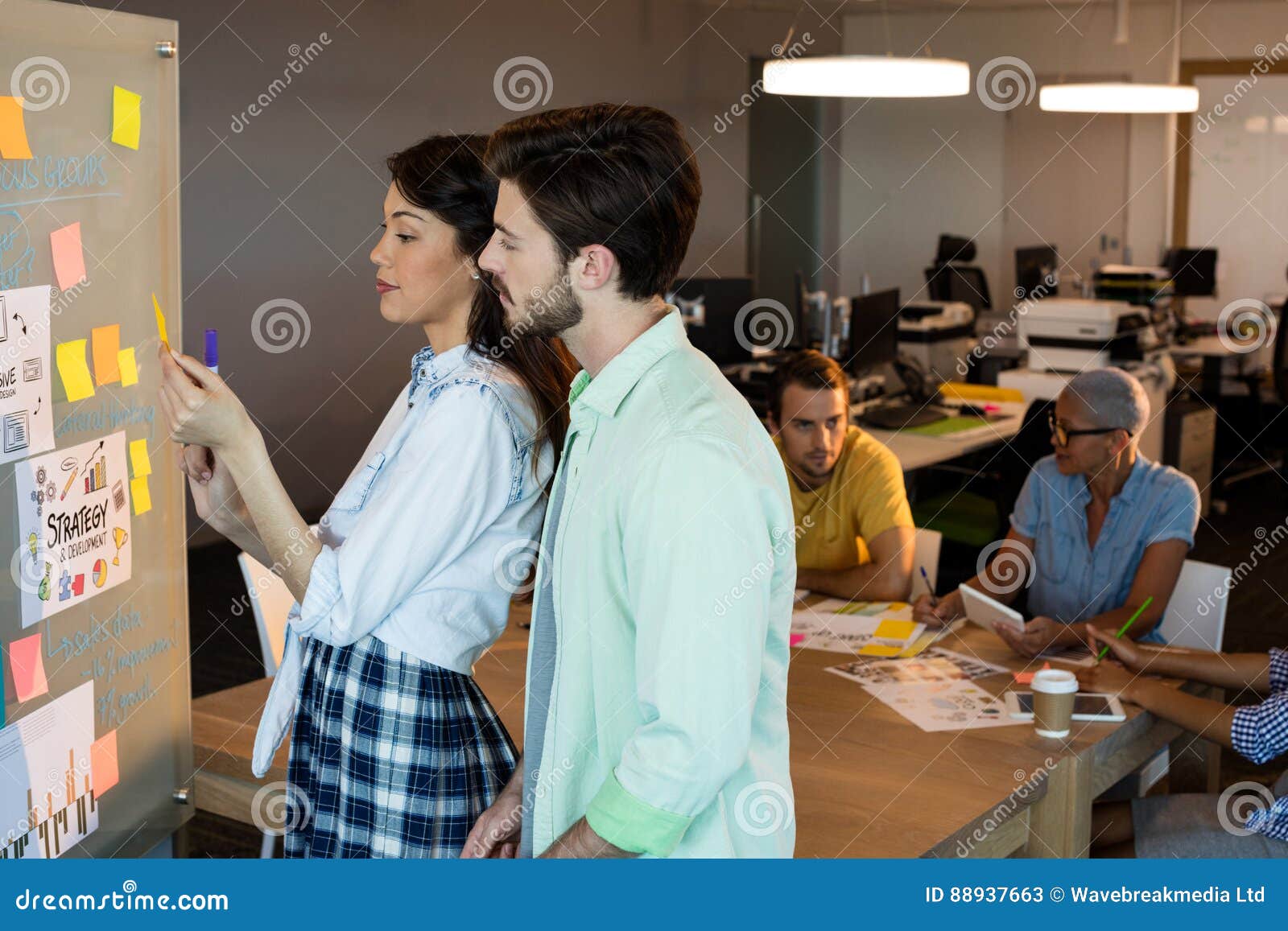 Creative Business People Looking at Sticky Notes on Glass Board Stock ...
