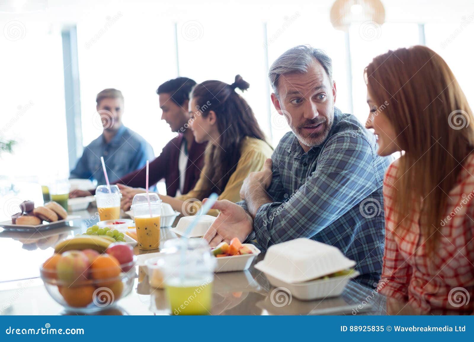 Creative Business Team Discussing while Having Meal Stock Image - Image ...