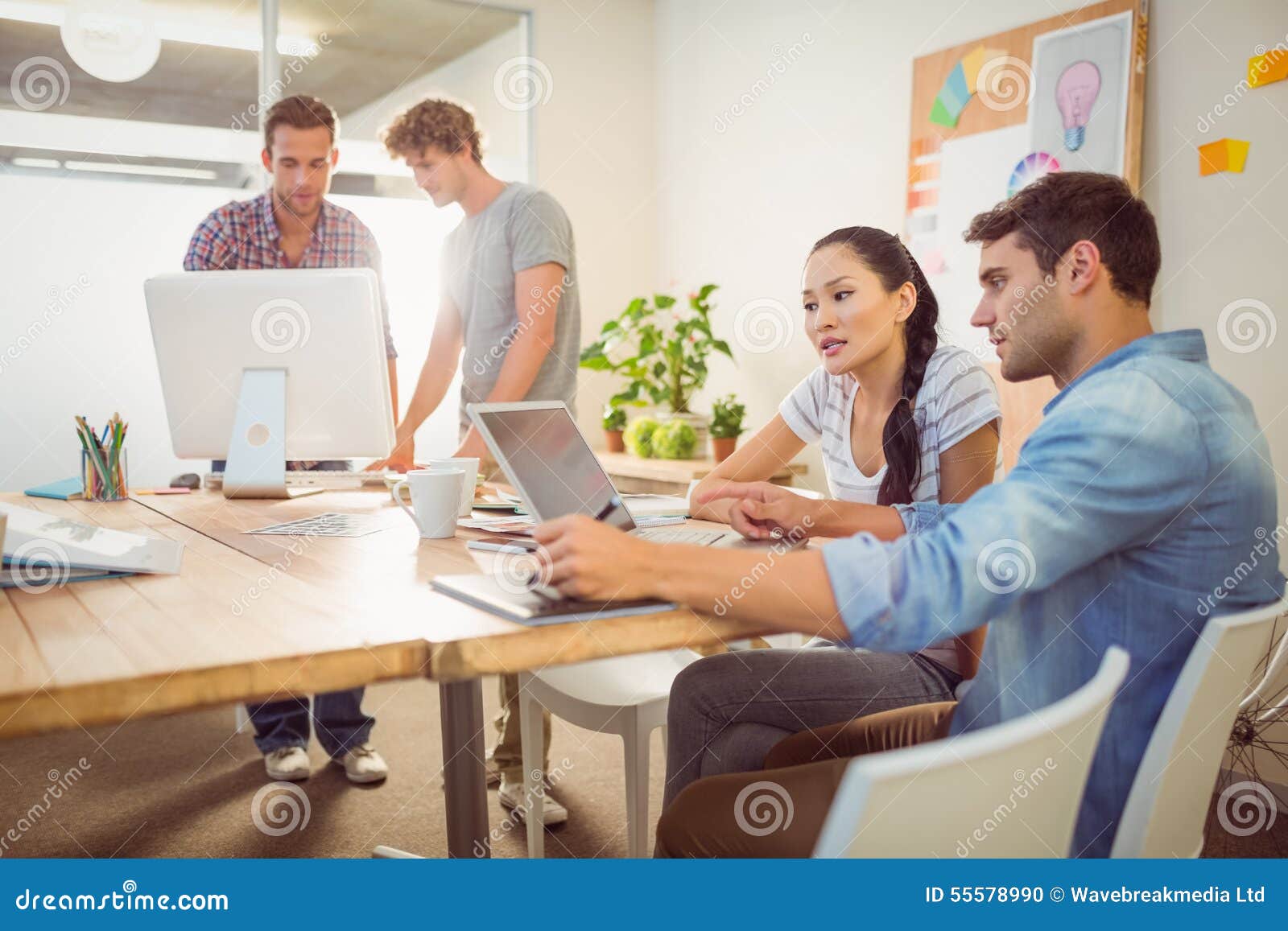 Creative Business Team Gathered Around Laptops Stock Photo - Image of ...