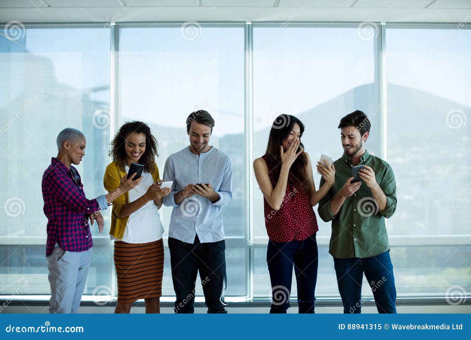 Creative Business Team Interacting while Using Mobile Phone Stock Image ...