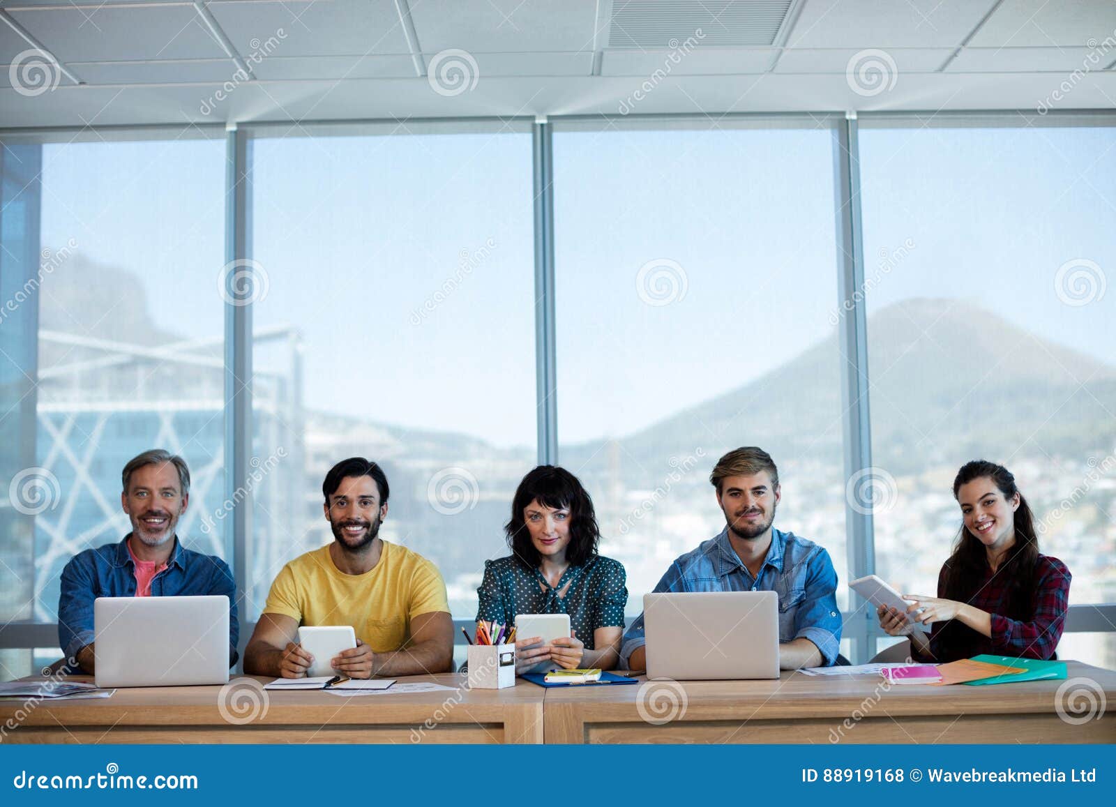 Creative Business Team Sitting in a Row and Working Together on Table ...