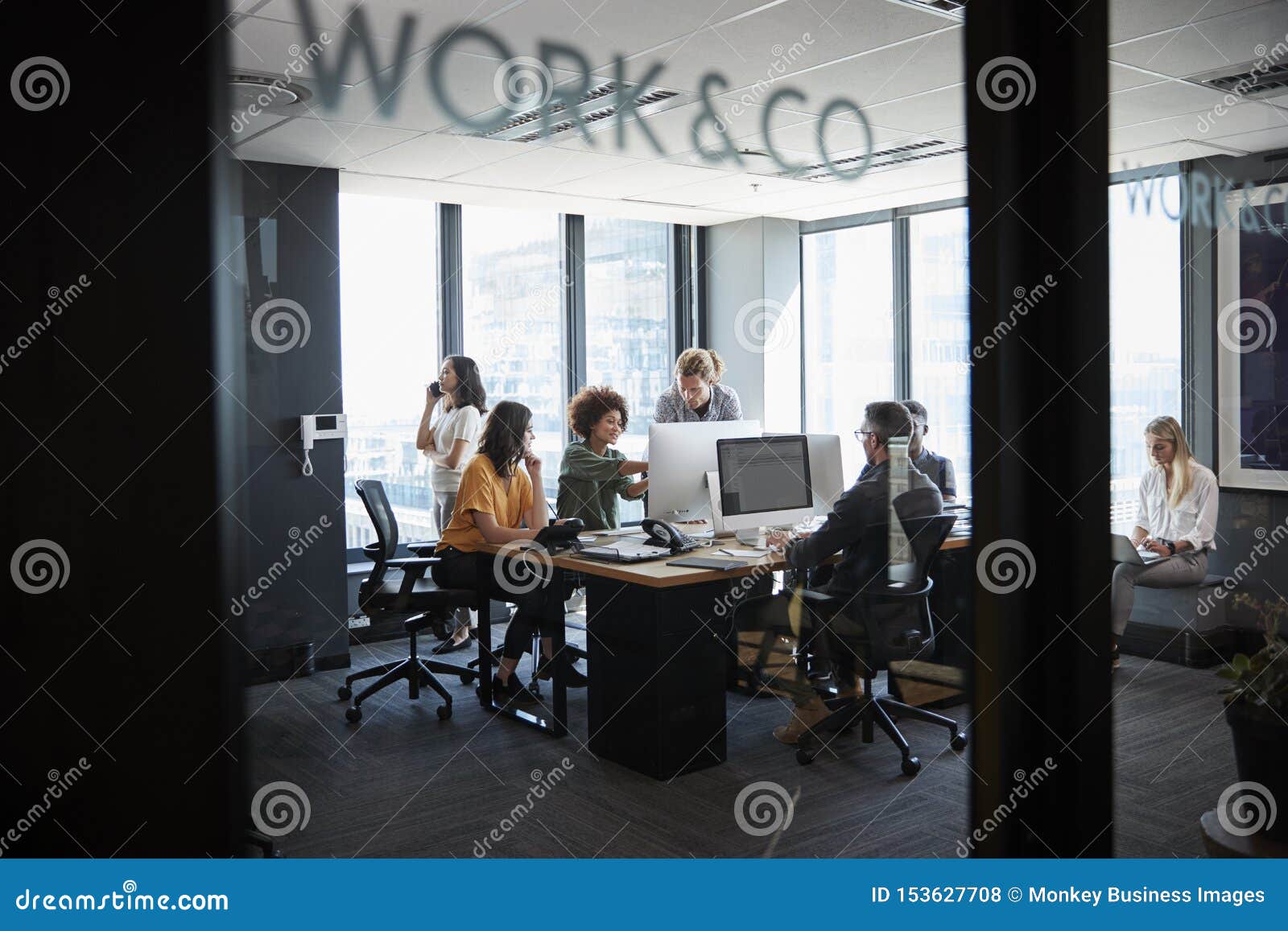Creative Business Team Working in a Casual Office, Seen through Glass ...