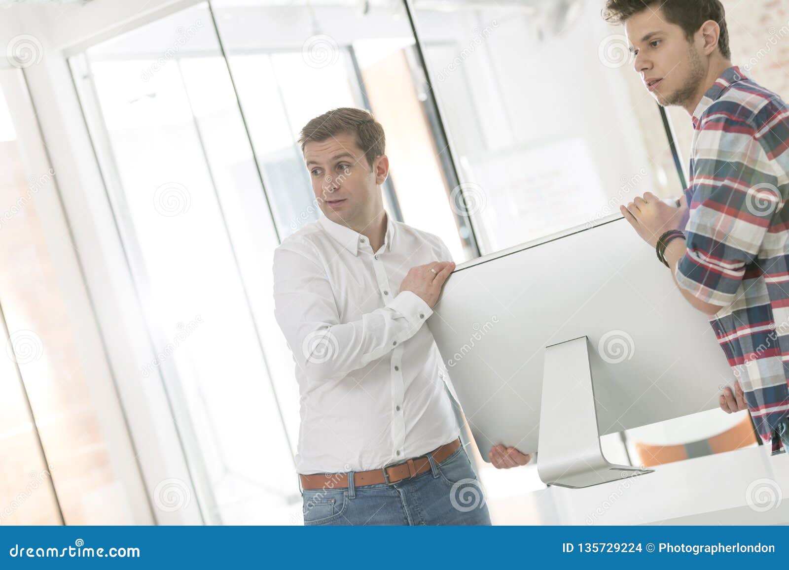 Creative Businessmen Carrying Desktop Computer in Office Stock Photo ...