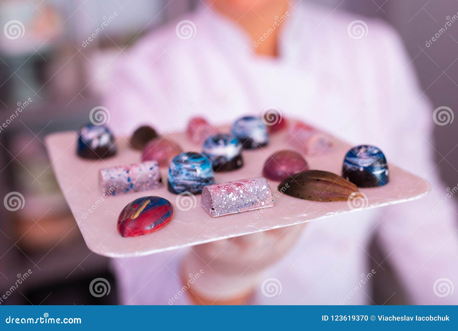 Experienced Confectioner Looking at Plate with Creative Chocolates ...