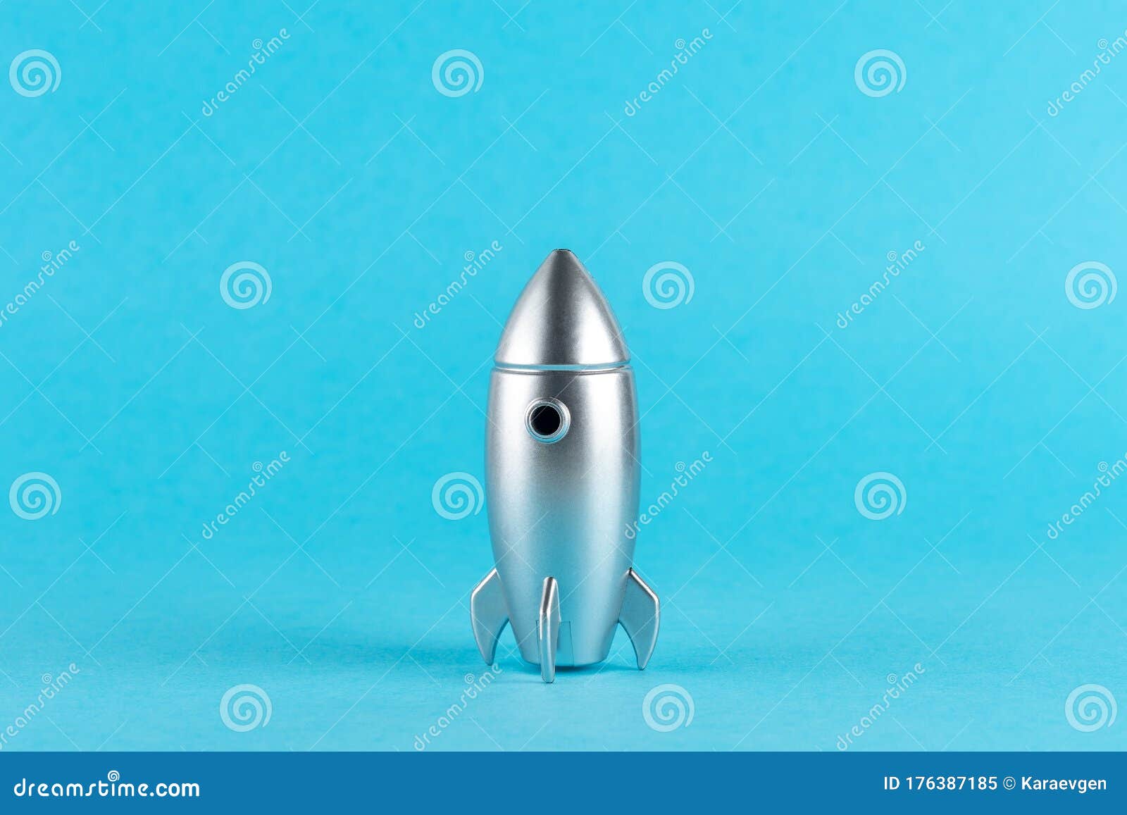 Creative Composition with Silver Rocket on Pastel Blue Background ...