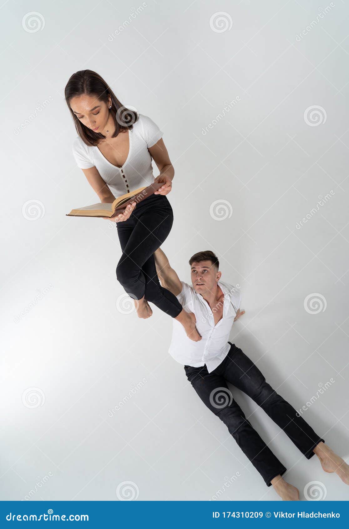Creative Composition of Woman Sitting on Man`s Hand and Reading Book ...