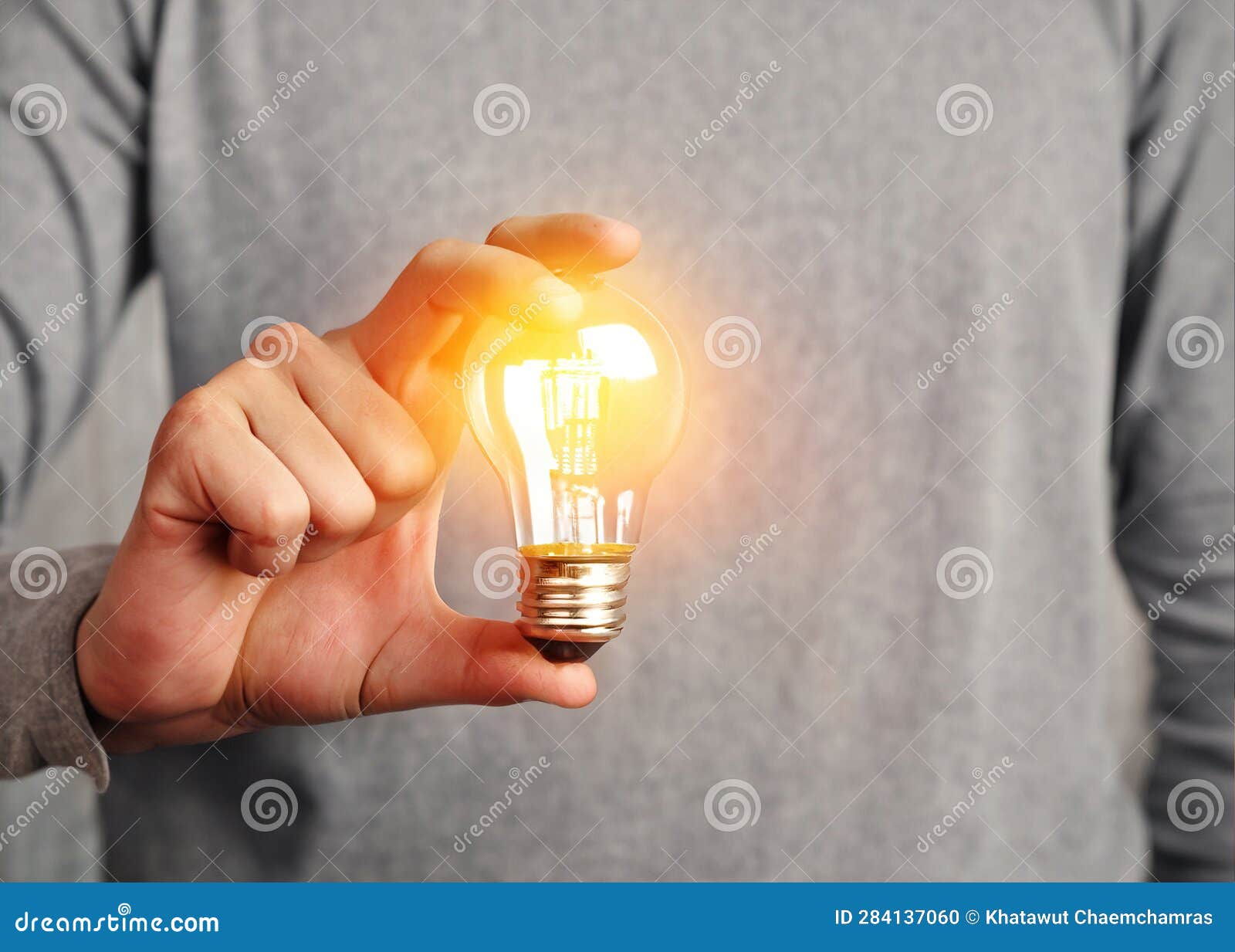 Creative Hand Holding Light Bulb, Symbolizing Innovation and Energy for ...