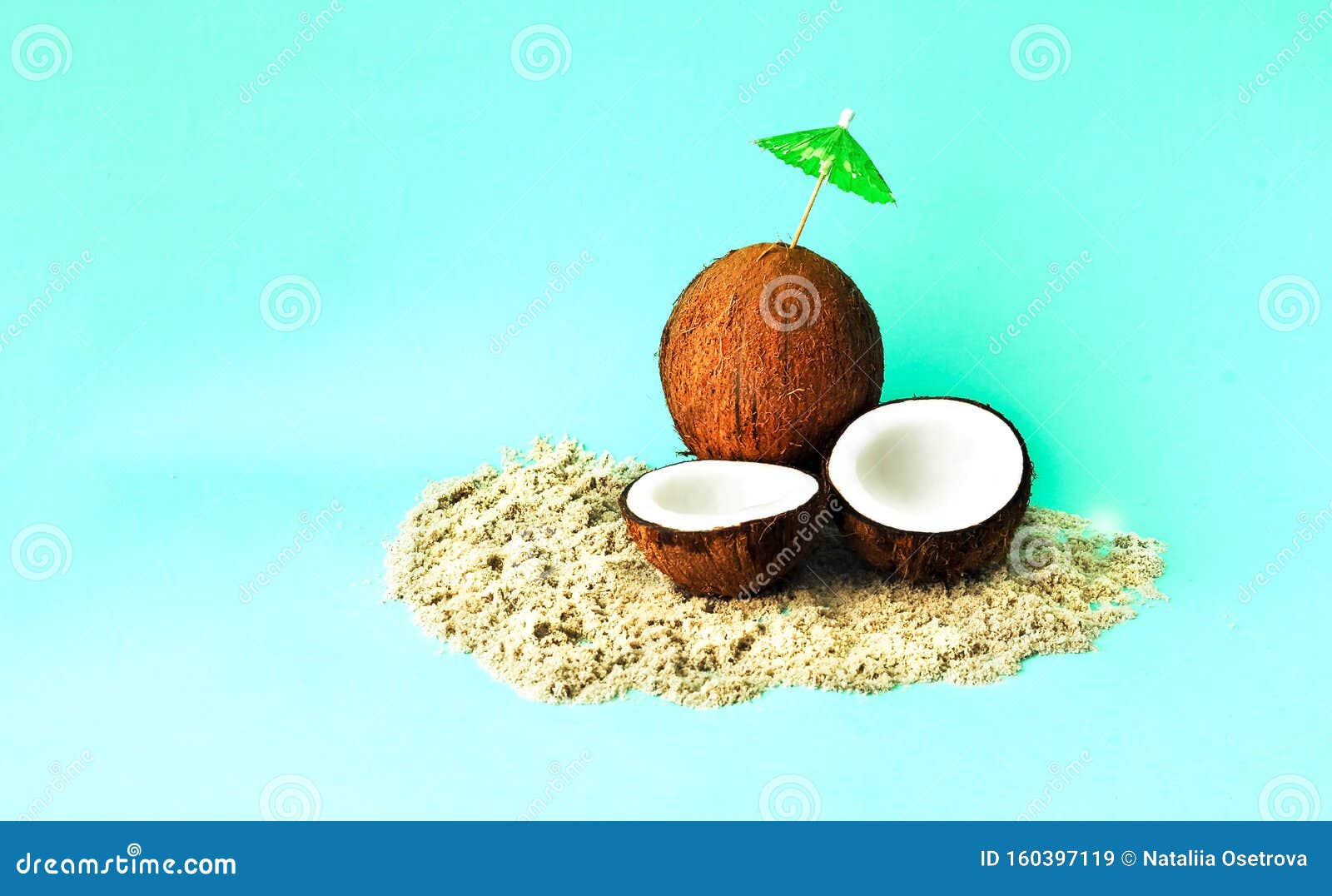 Creative Layout of Coconuts Mit Decorative Umbrella on Sand Texture ...