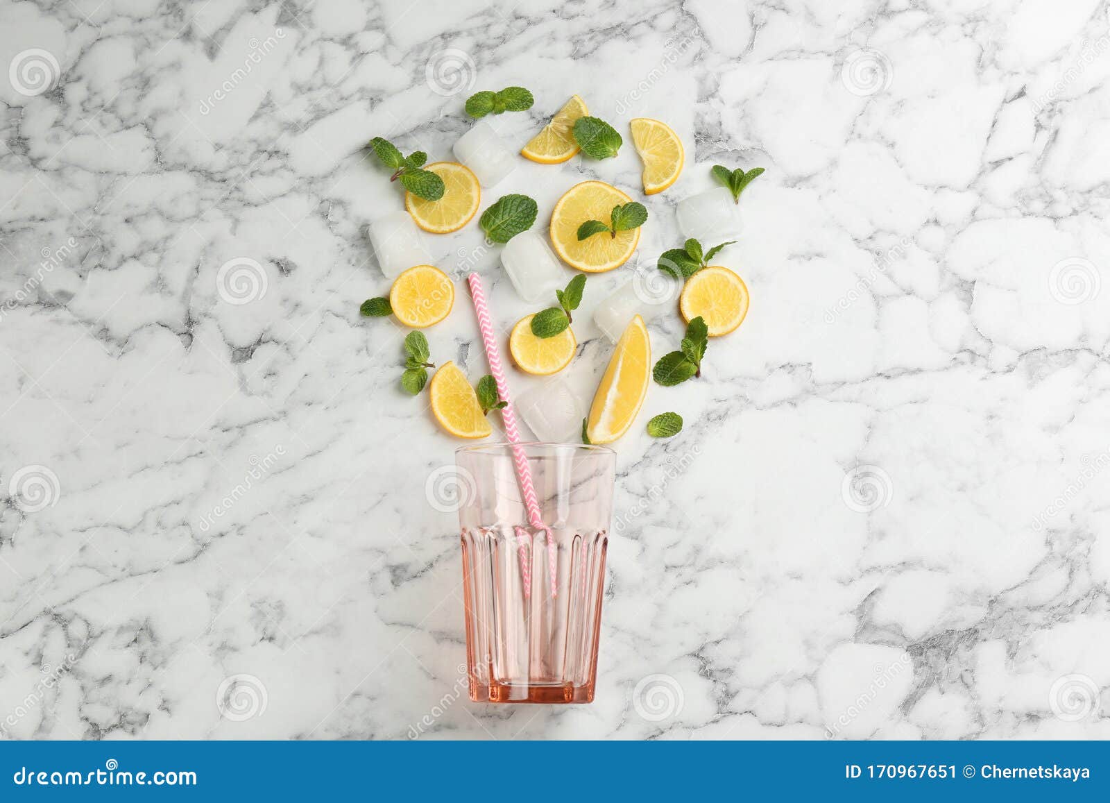 Creative Lemonade Layout with Lemon Slices, Mint and Ice on White Table ...