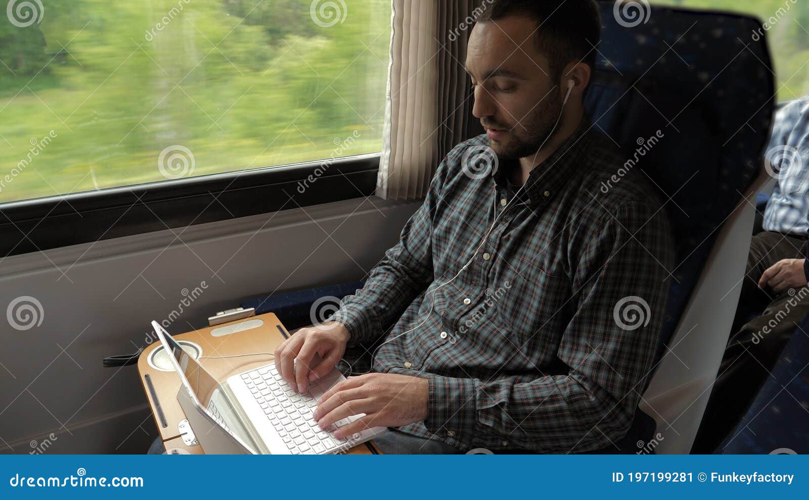 Creative Man Designer Working on His Laptop Computer in a Train. Stock ...