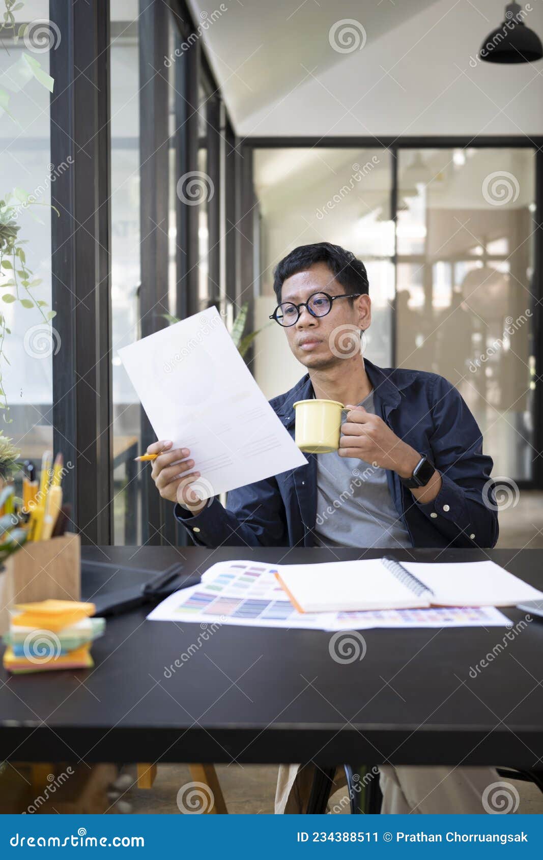 Man Drinking Coffee and Working in Modern Workplace. Stock Image ...