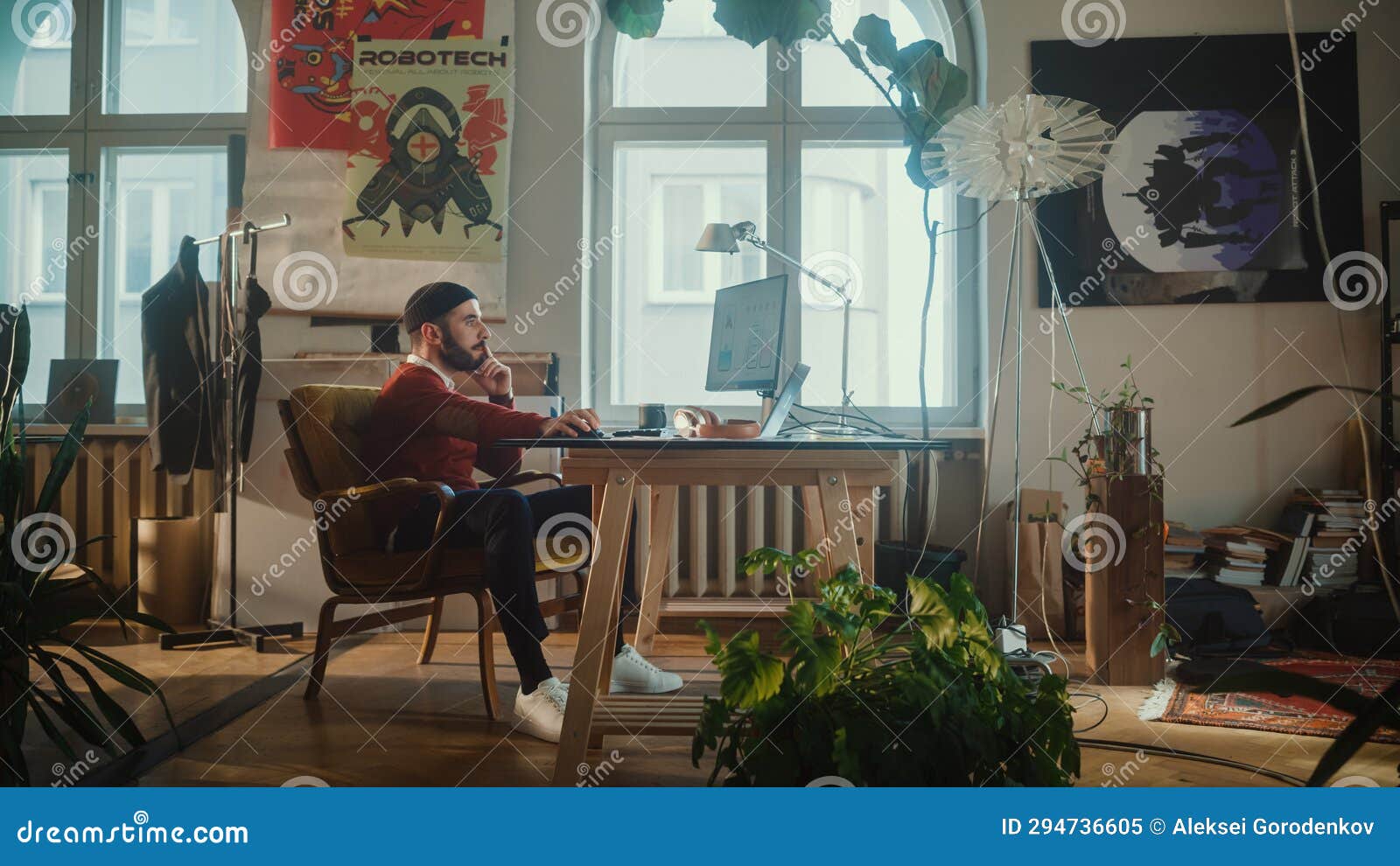 Creative Modern Office: Young Man Sitting at His Desk Working on ...