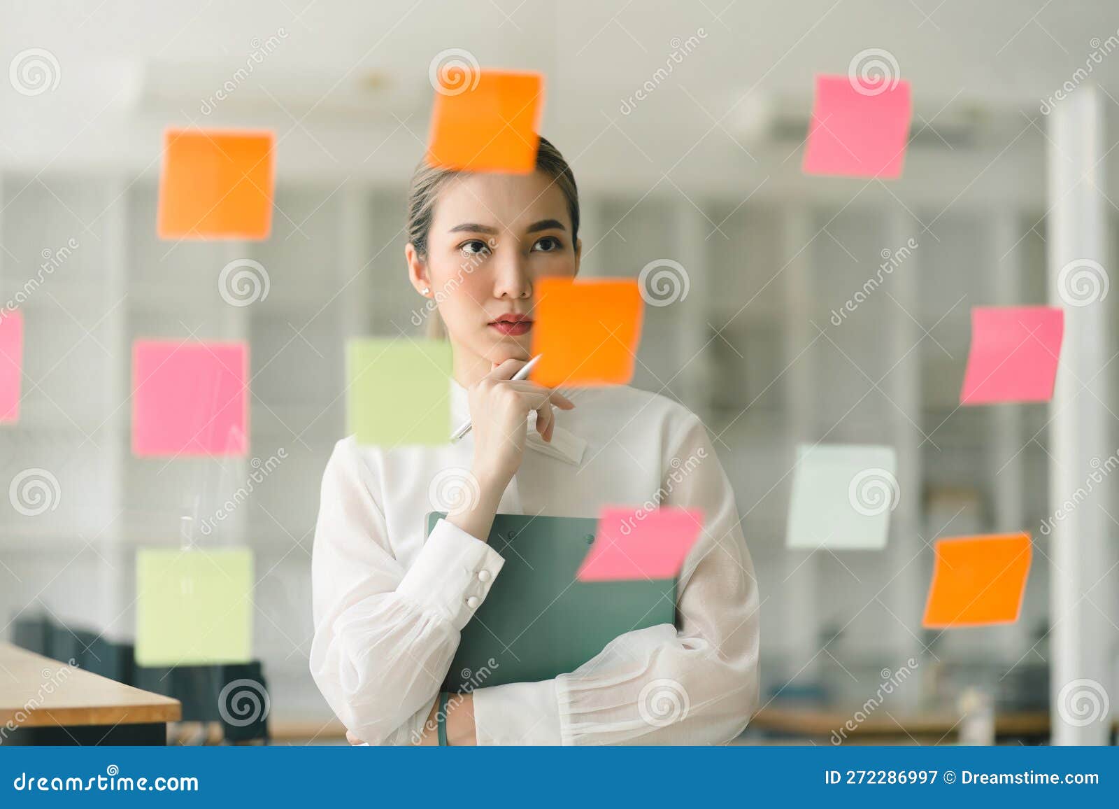 In a Creative Office, a Startup Young and Confident Businesswoman is ...