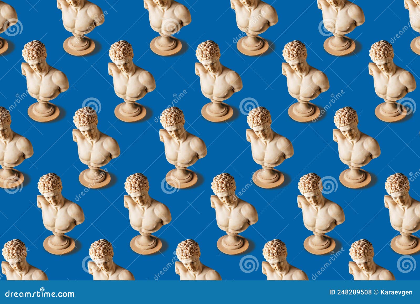 Creative Pattern Made of Old Statues on Blue Background. Minimal Art ...