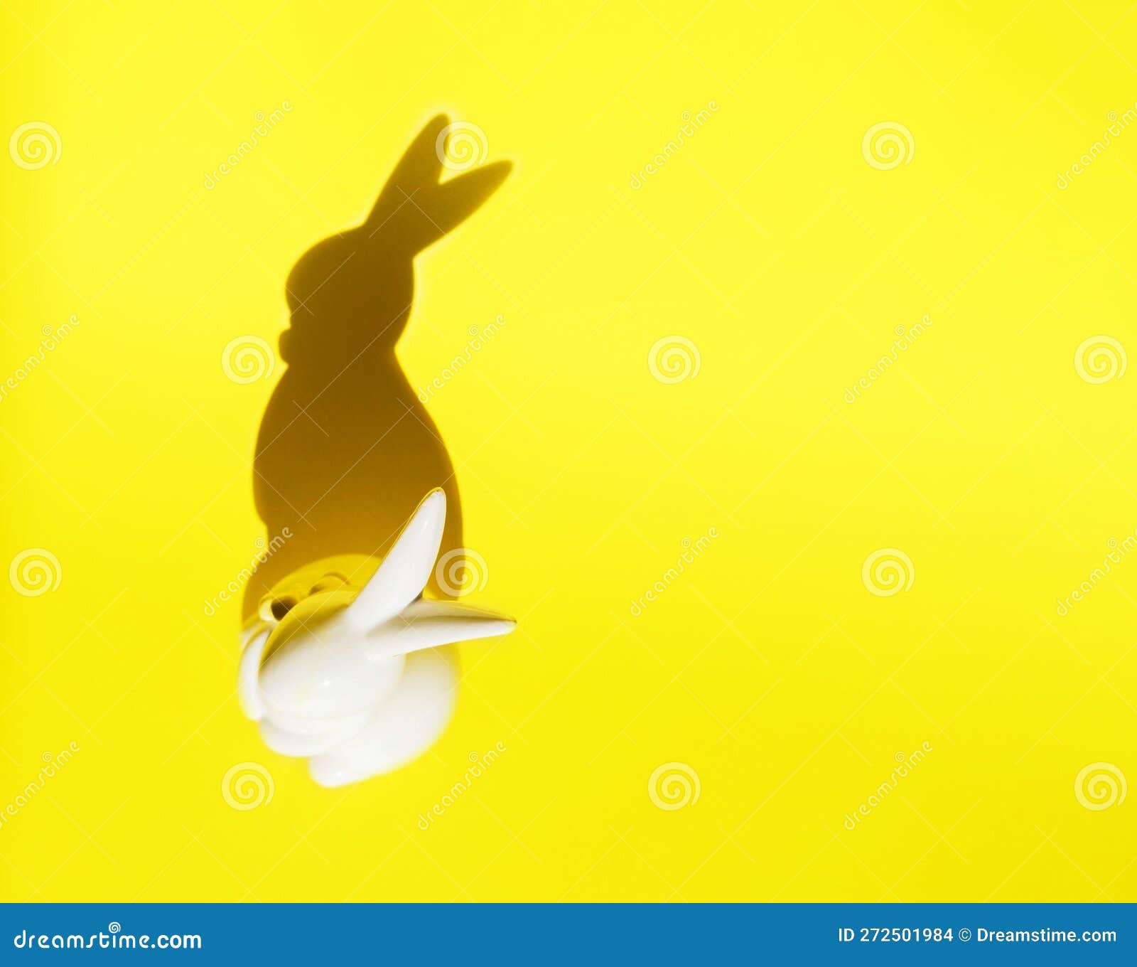 Creative Photo. Ceramic Easter Bunny on a Yellow Monochrome Background ...