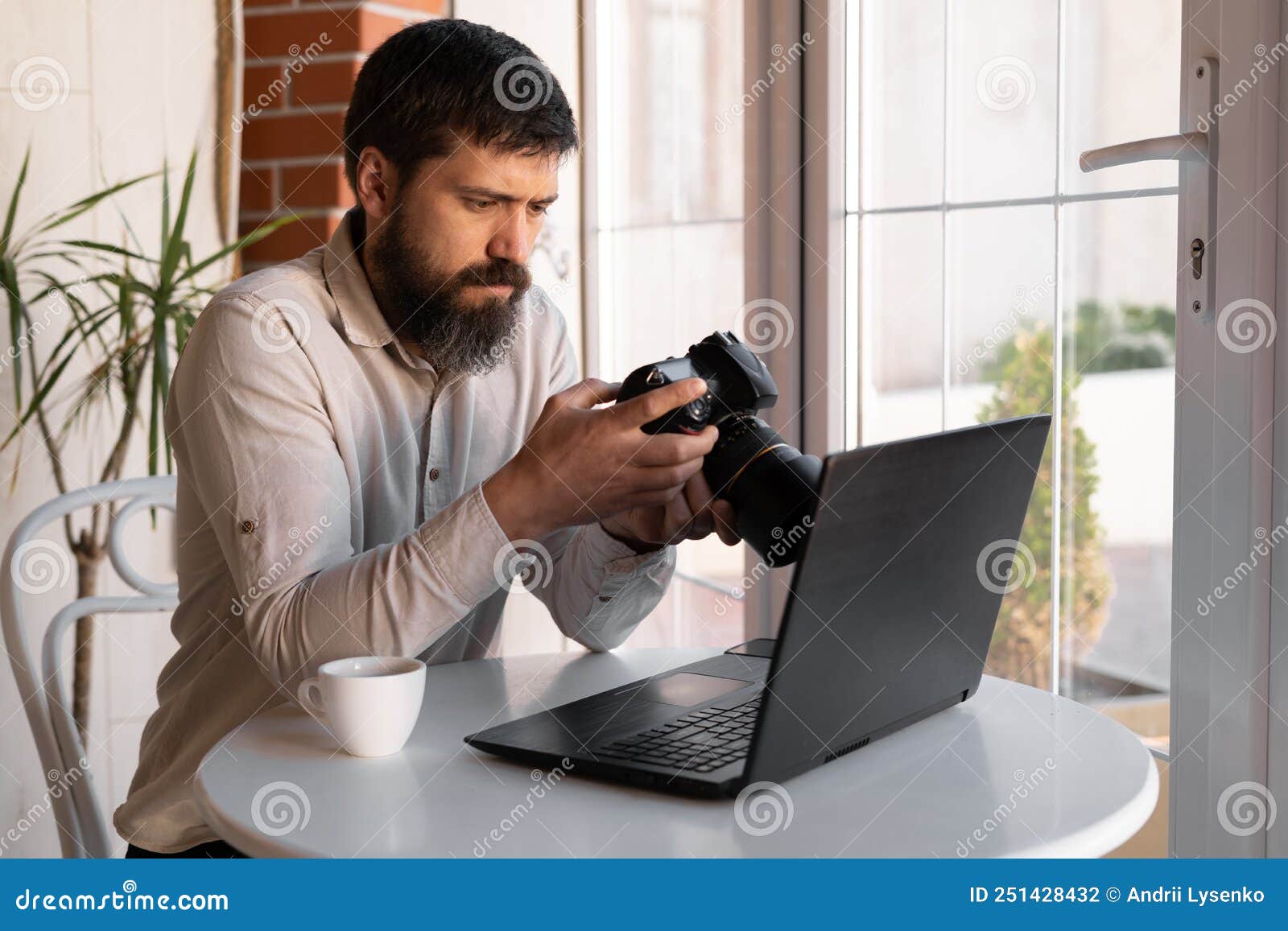 Creative Photographer Working with Laptop and Digital Camera at Cafe ...