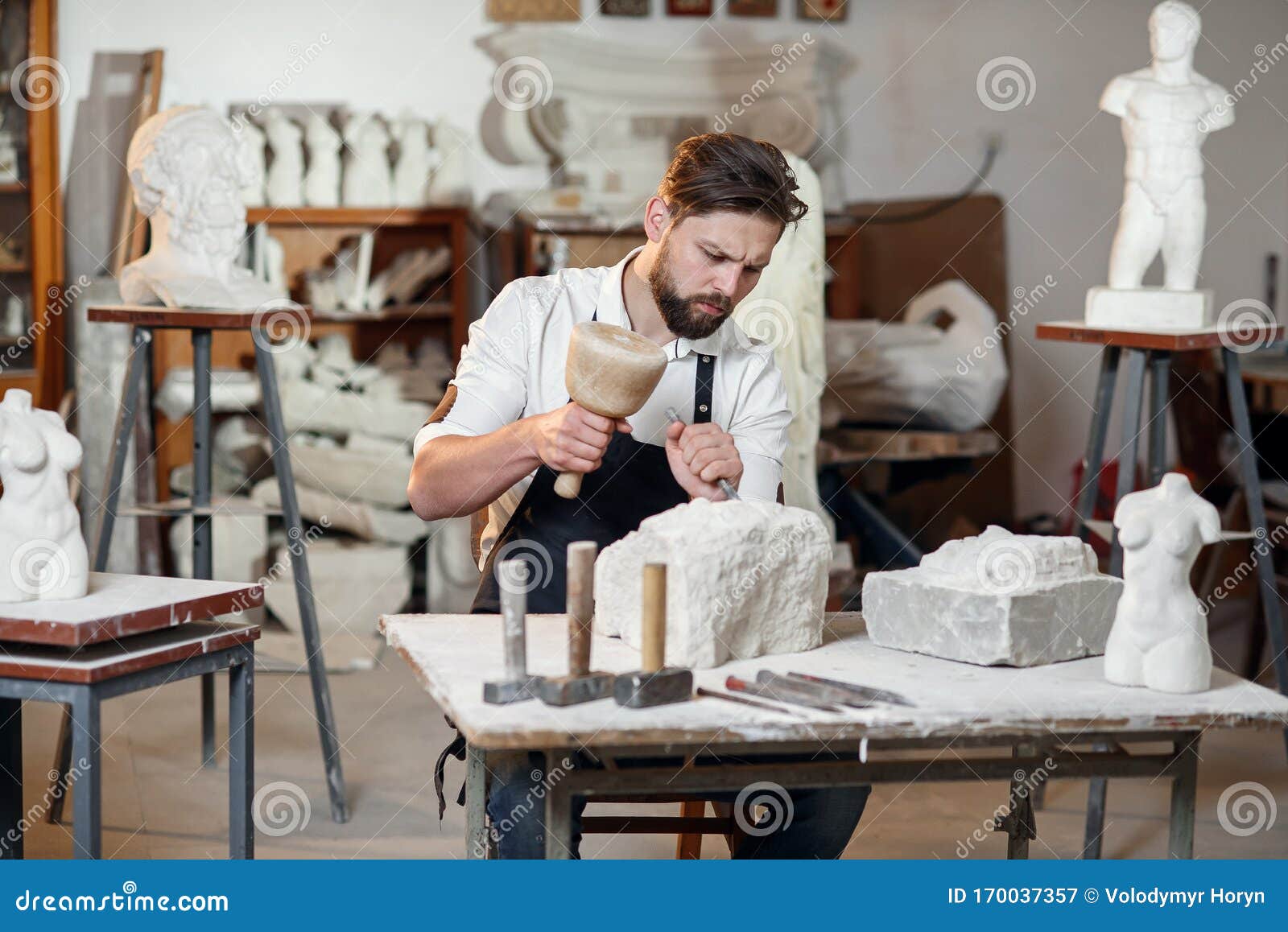 Stone Carver Works with Wooden Hammer and Chisel at Limestone. Stock ...