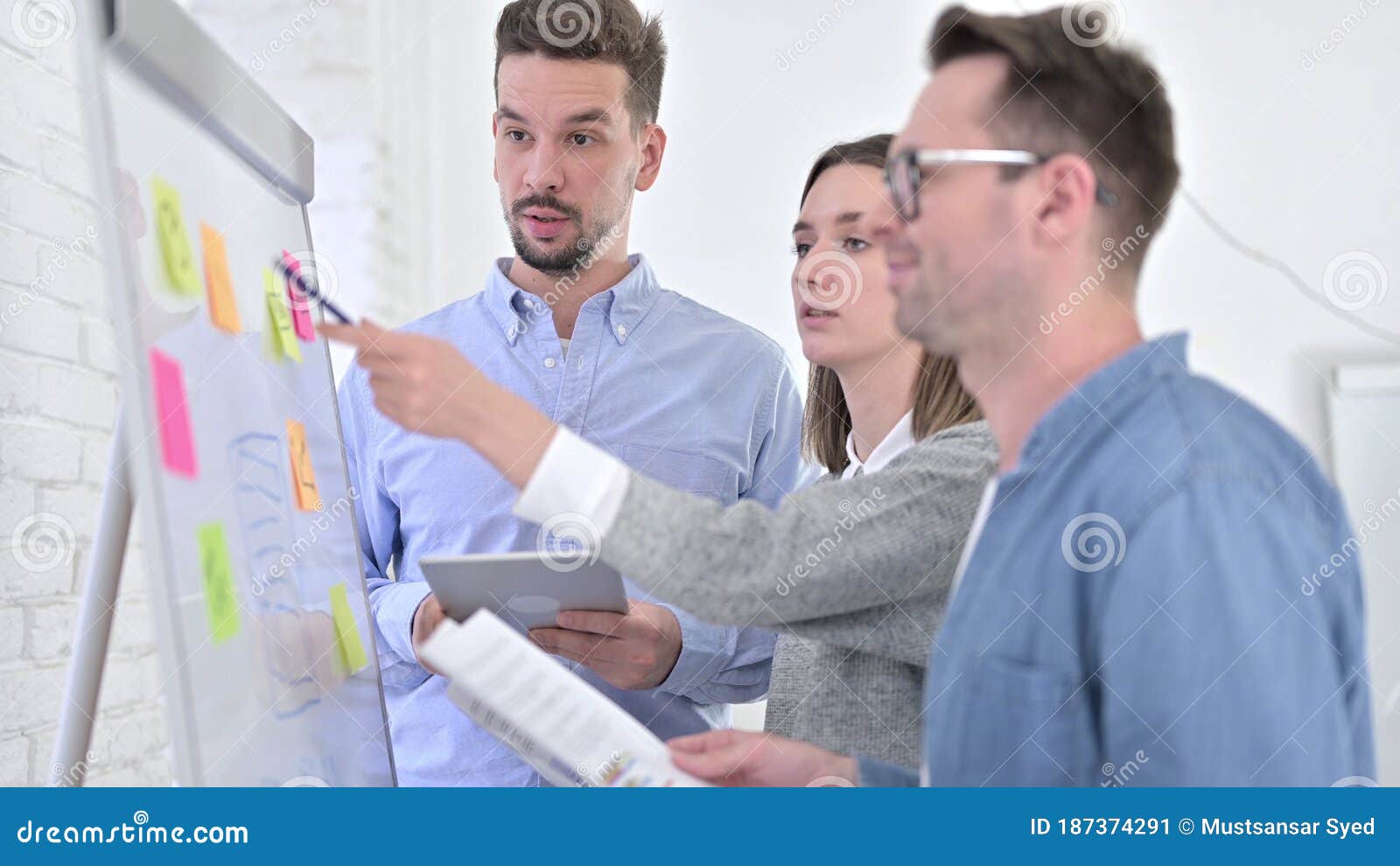 Creative Startup Team Discussing Project Ideas on Whiteboard Stock ...