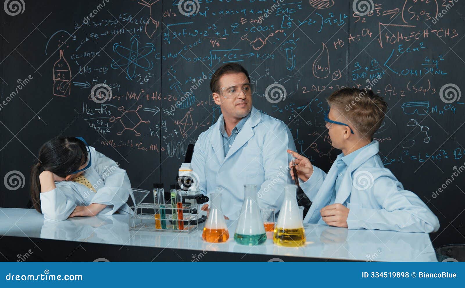 Creative Teacher Pointing at Blackboard while Talking To Smart Boy ...