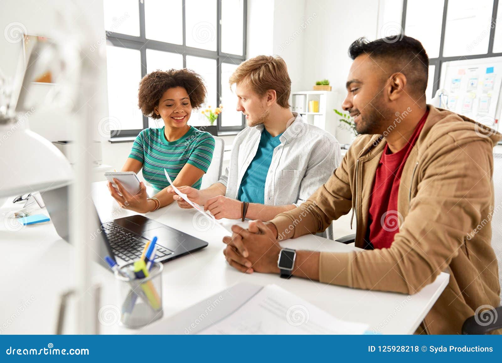 Creative Team Discussing Papers at Office Stock Photo - Image of happy ...