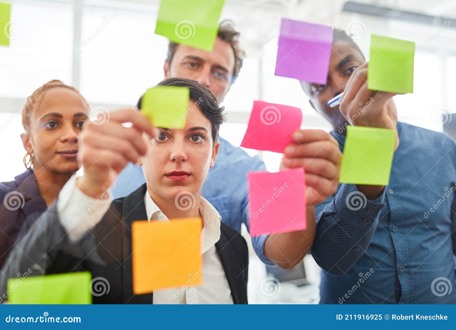 Creative Team Looks at Sticky Notes on the Glass Stock Image - Image of ...