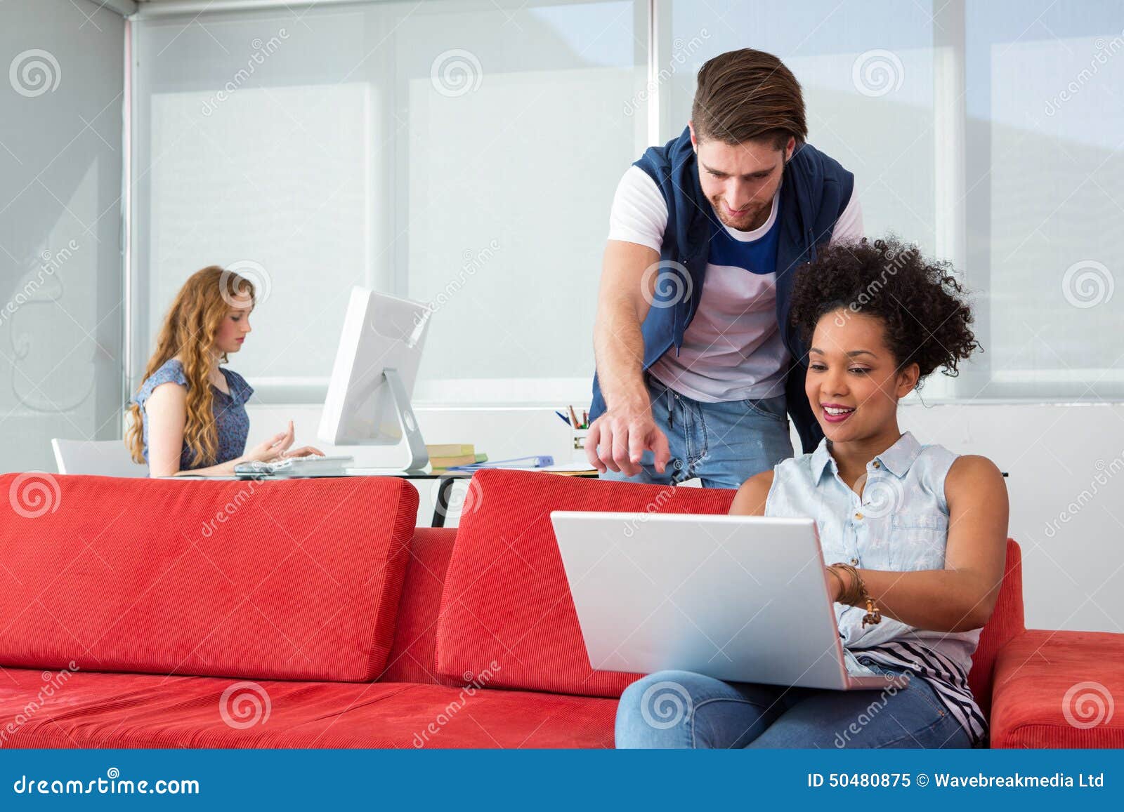 Creative team using laptop stock image. Image of couch - 50480875