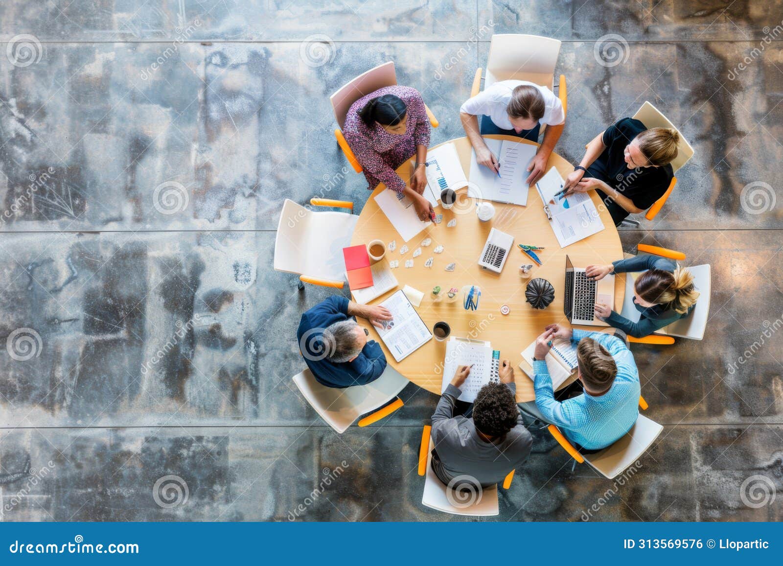 Creative Team Working Together at a Rustic Wooden Table in a Modern ...