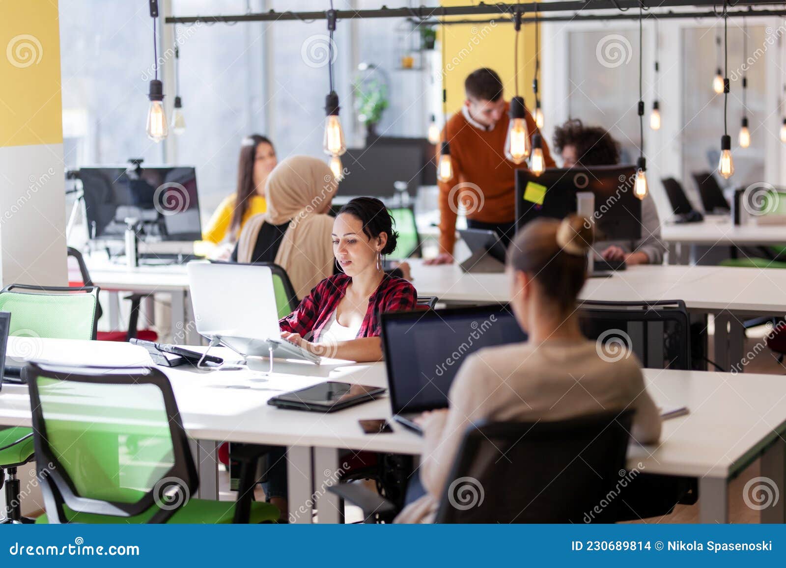 Creative Team of Young Individuals Working on Desktop Computers in a ...