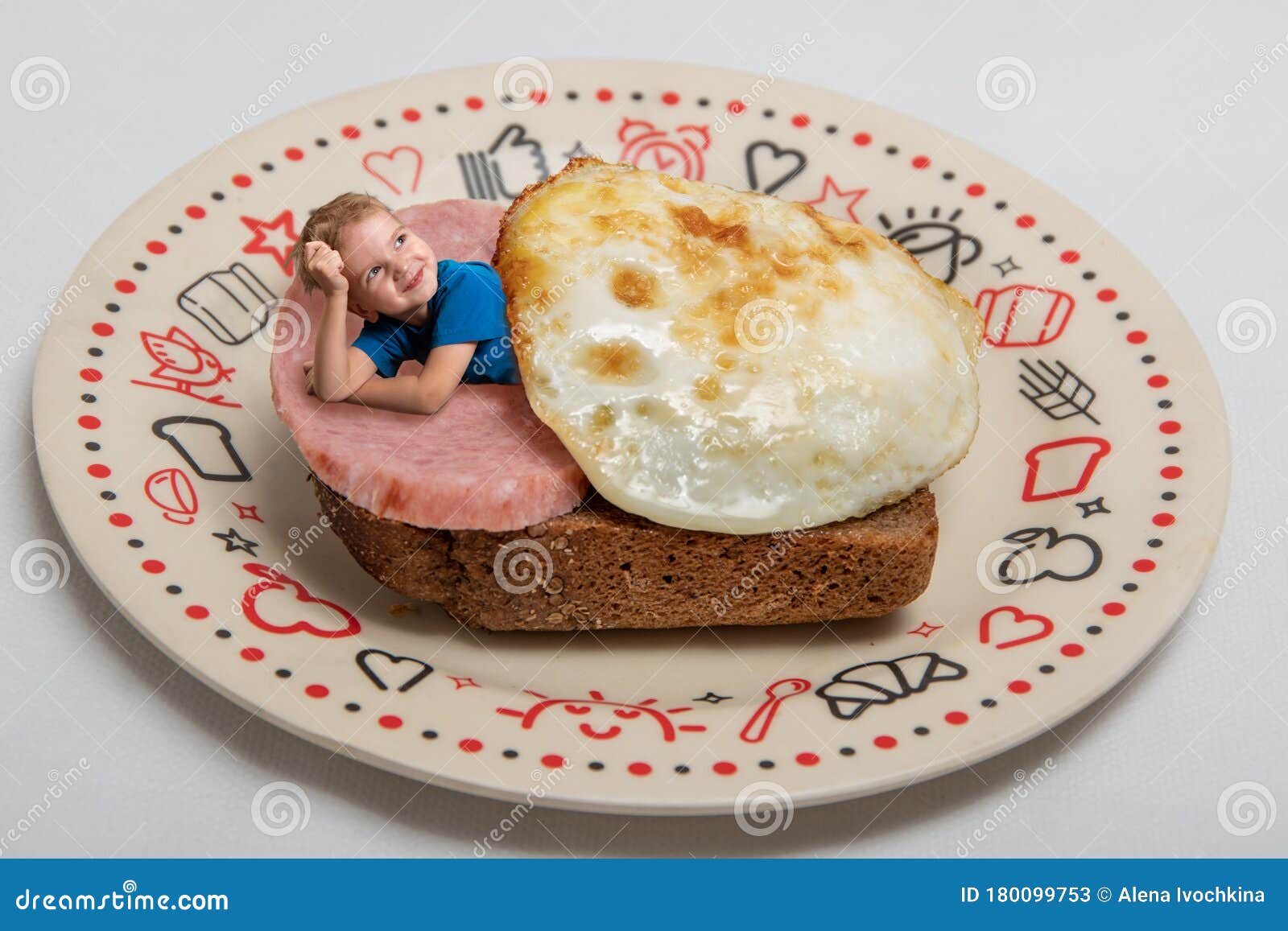 Creative Work: a Boy Lies on a Toast Bread with an Egg and Sausage on a ...