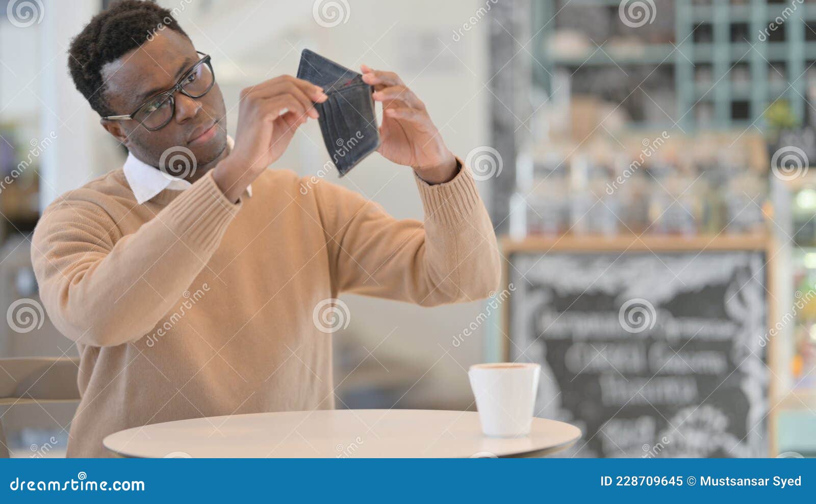 African Man Checking Empty Wallet while Sitting in Cafe Stock Image ...