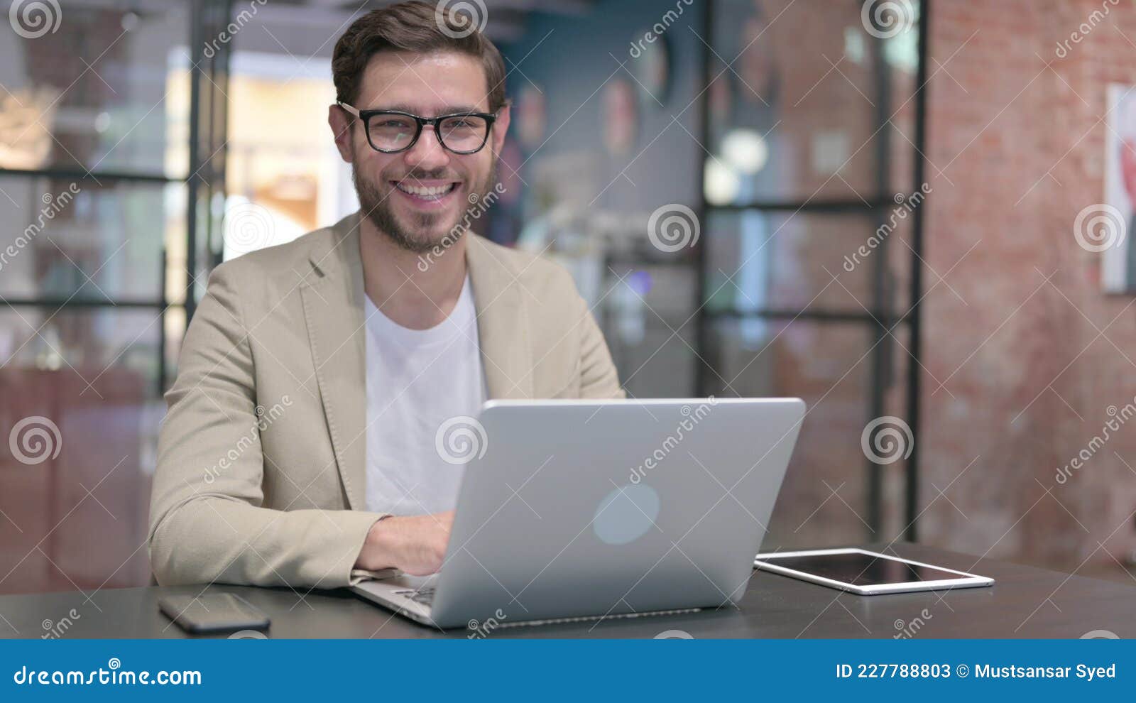 Young Man with Laptop Smiling at Camera Stock Image - Image of online ...