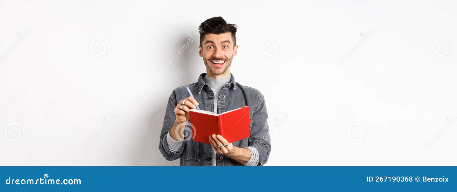 Creative Young Man Smiling Excited while Taking Notes, Writing Down ...
