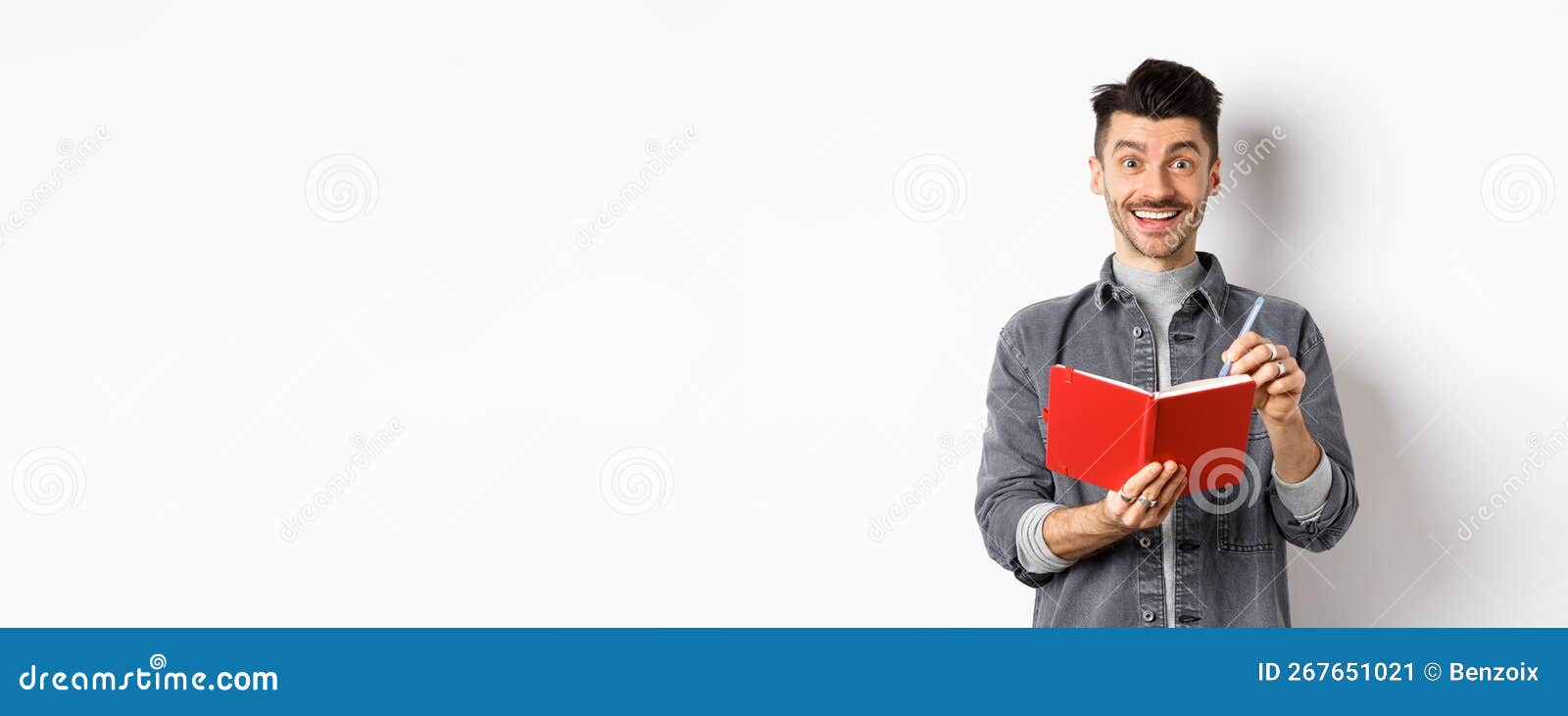Creative Young Man Smiling Excited while Taking Notes, Writing Down ...