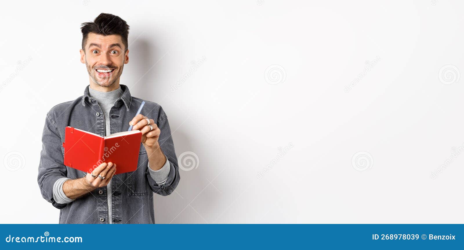 Creative Young Man Smiling Excited while Taking Notes, Writing Down ...