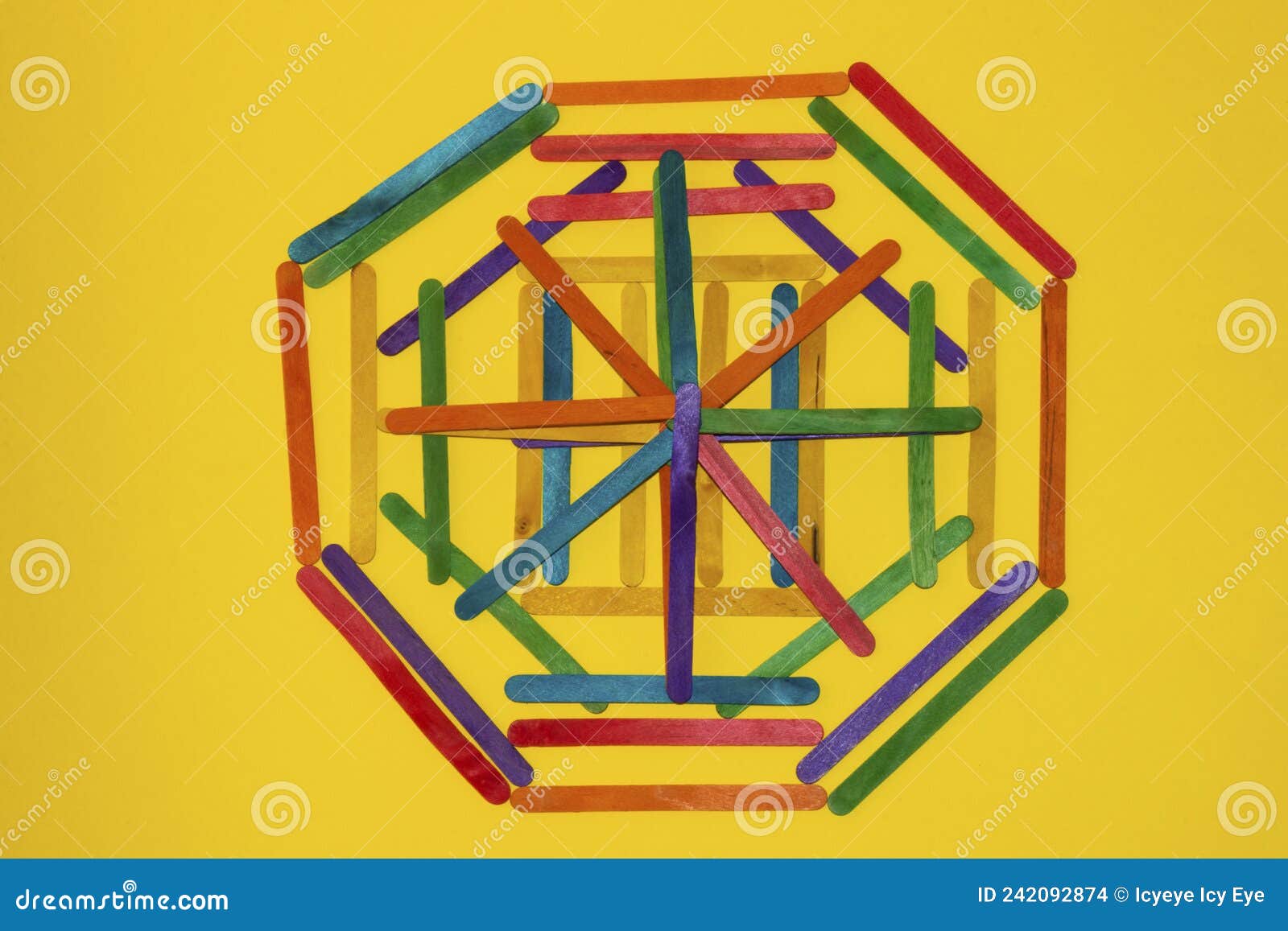 Creatively Arranged Colorful Sticks on a Yellow Background Stock Photo ...