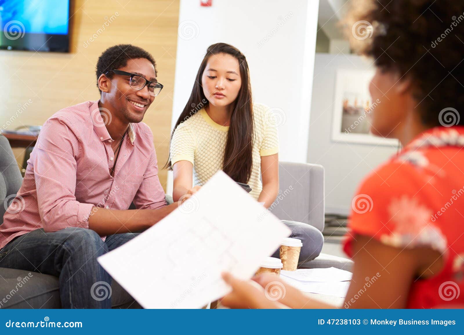 Creatives Having Informal Meeting on Sofas in Design Studio Stock Image ...