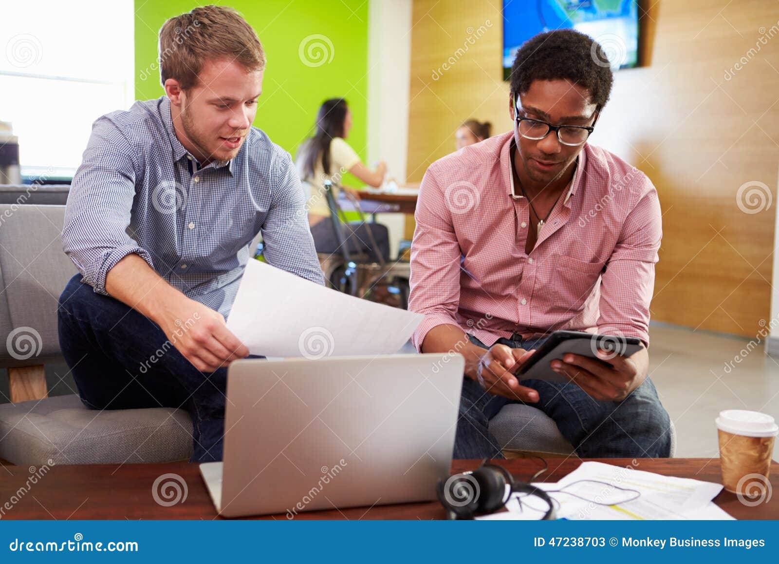 Creatives Having Informal Meeting on Sofas in Design Studio Stock Image ...