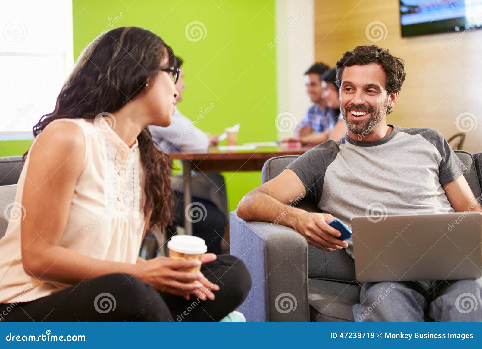 Creatives Having Informal Meeting on Sofas in Design Studio Stock Image ...