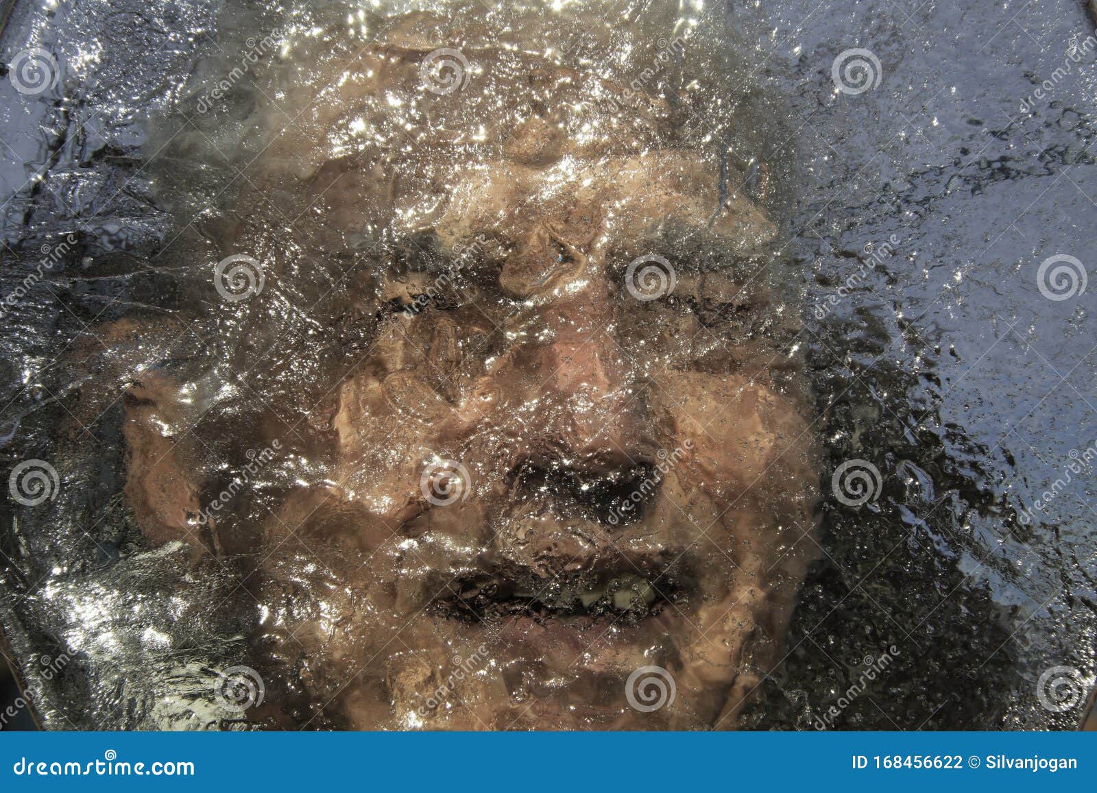 A Creepy Deformed Mans Face Under Layer of Ice Stock Photo - Image of ...