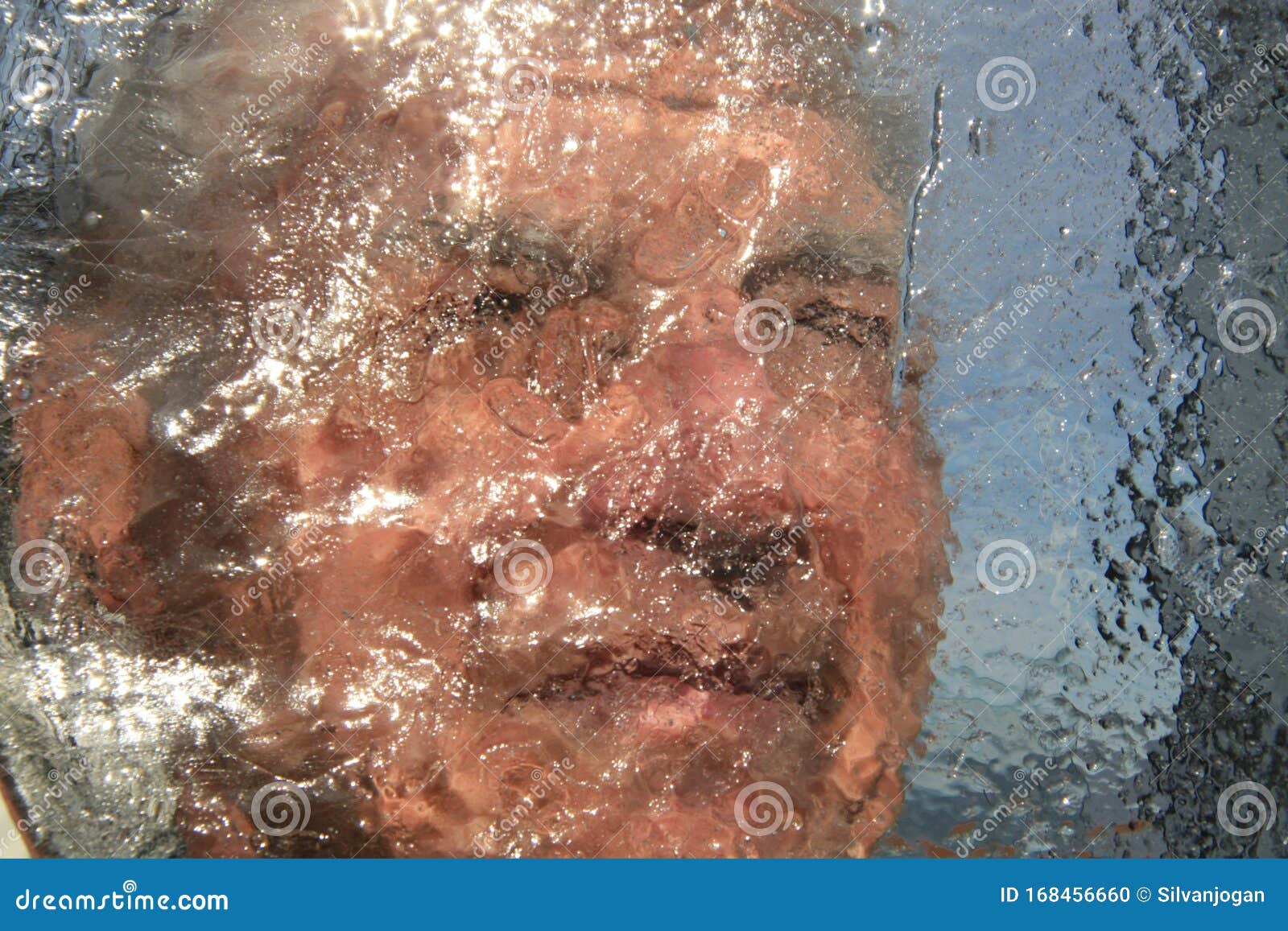 A Creepy Deformed Mans Face Under Layer of Ice Stock Photo - Image of ...