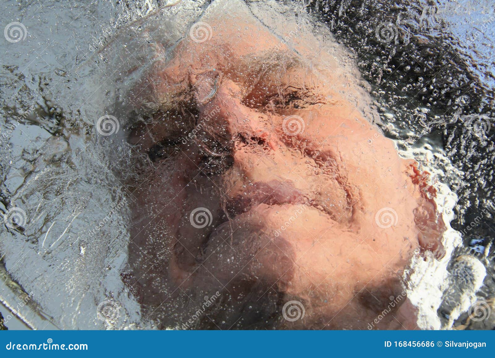 A Creepy Deformed Mans Face Under Layer Of Ice Stock Image ...