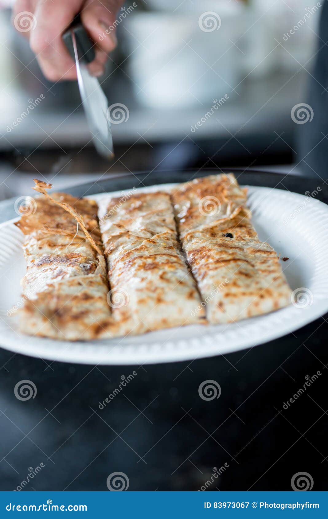 Crepe in Paper Plate Sliced into Three with Knife Stock Image - Image ...
