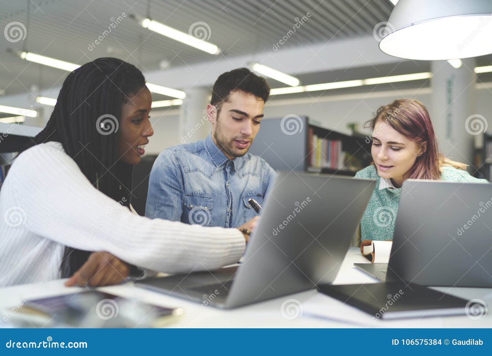 Multiracial Group of International Students Collaborating Working on ...