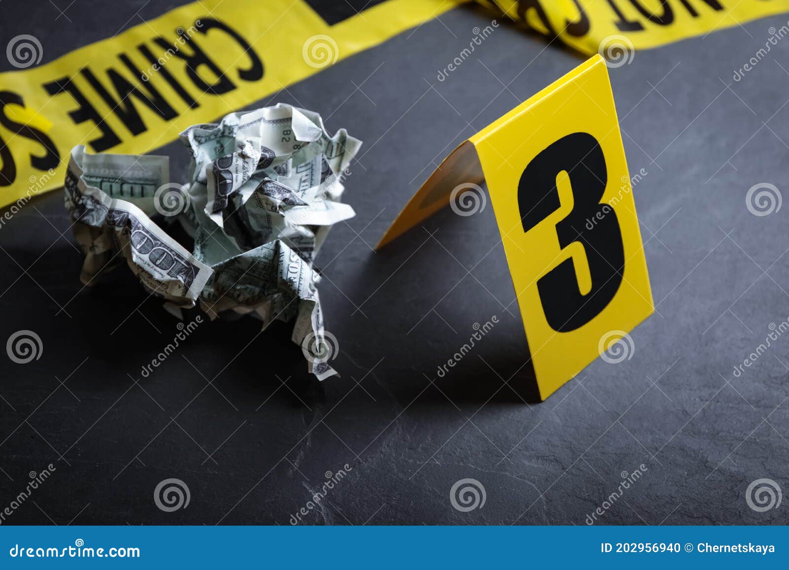 Crime Scene Marker and Crumpled Dollars on Black Slate Table, Closeup ...