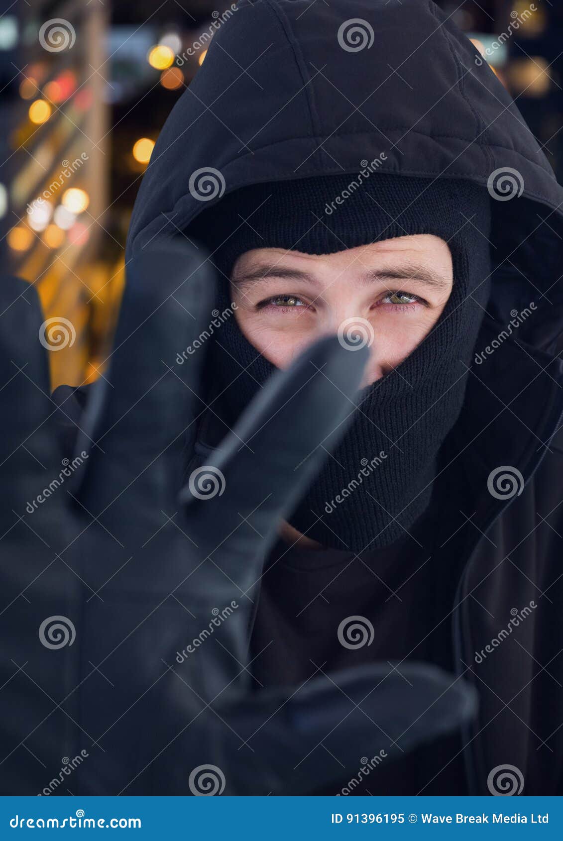 Criminal in Hood in Front of Night City Stock Image - Image of ...