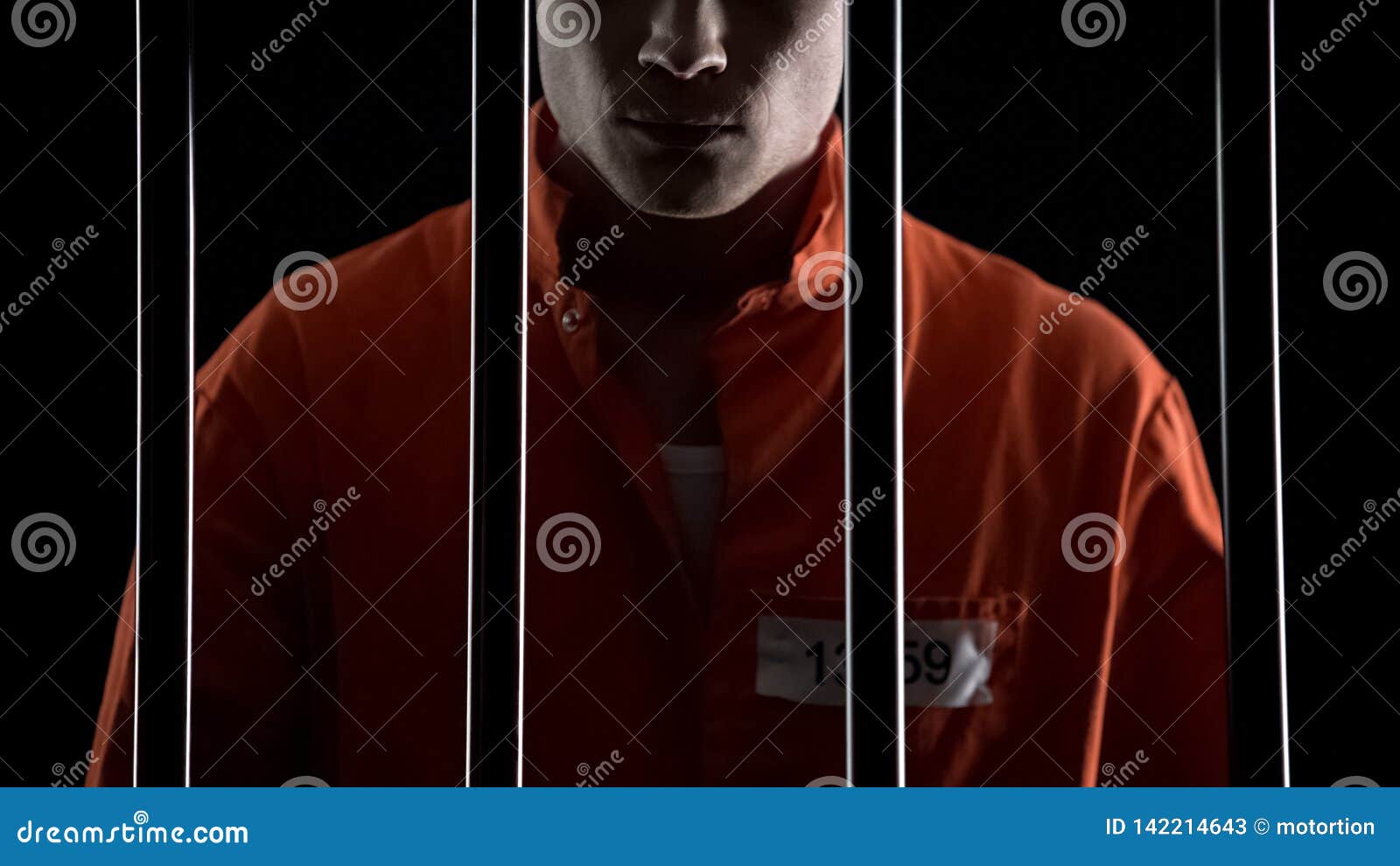 Criminal In Orange Uniform Behind Prison Bars Serving Life Sentence