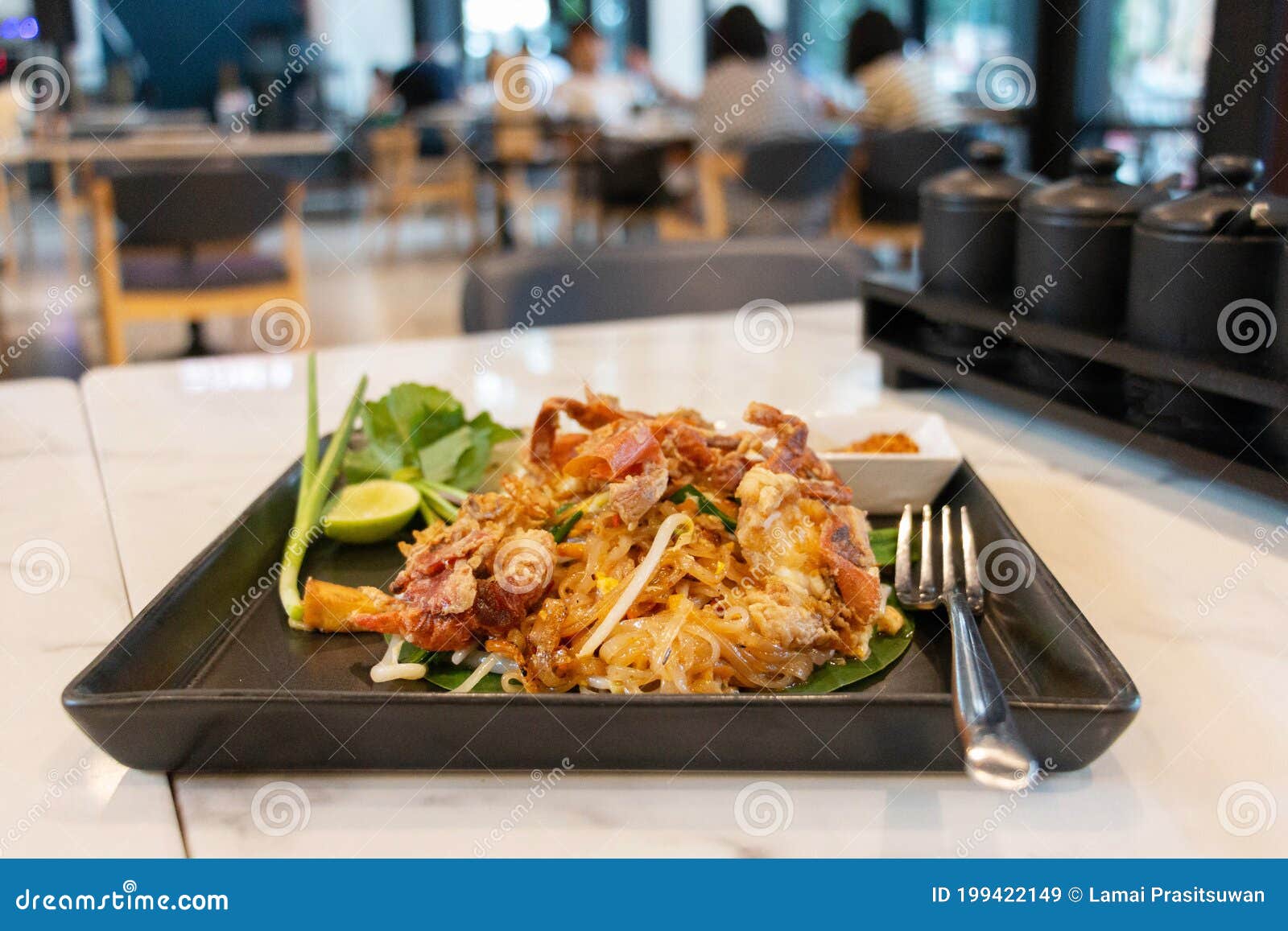 Crispy Crabs Pad Thai in Black Plate on White Table in Restaurant Stock ...