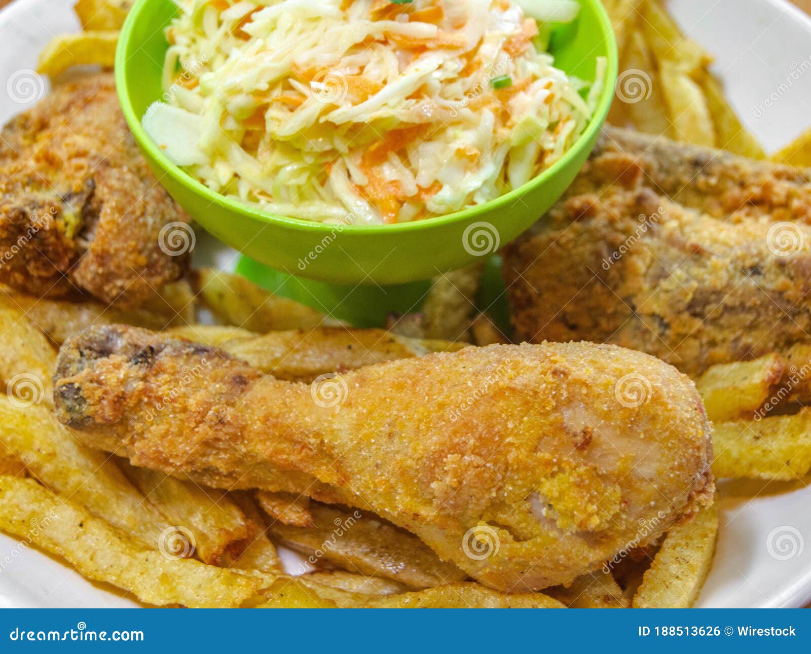 Crispy Fried Chicken and Potatoes with a Vegetable Salad Stock Photo ...